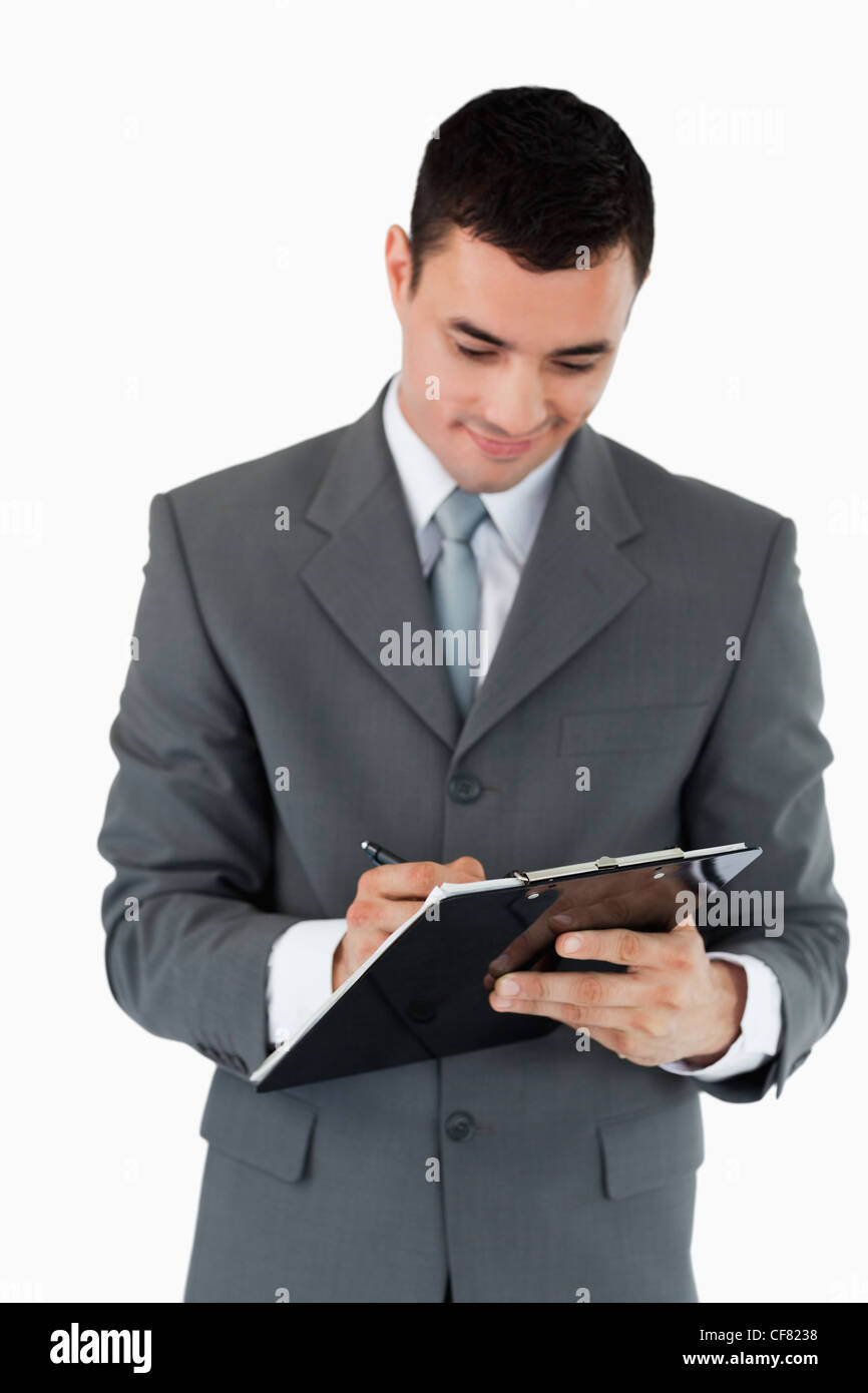 Businessman taking notes on clipboard Stock Photo - Alamy