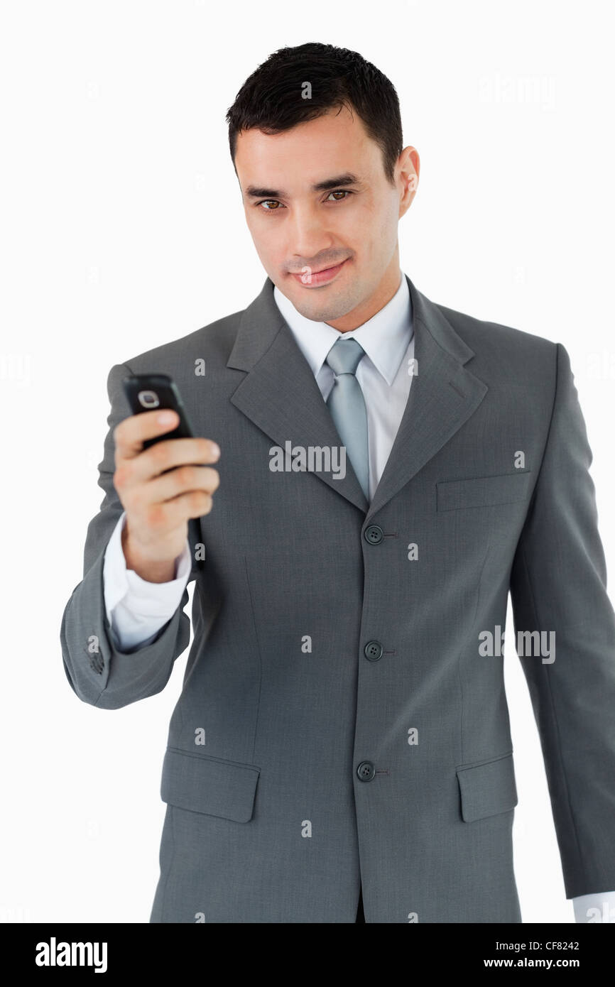 Confident businessman with his cellphone Stock Photo - Alamy