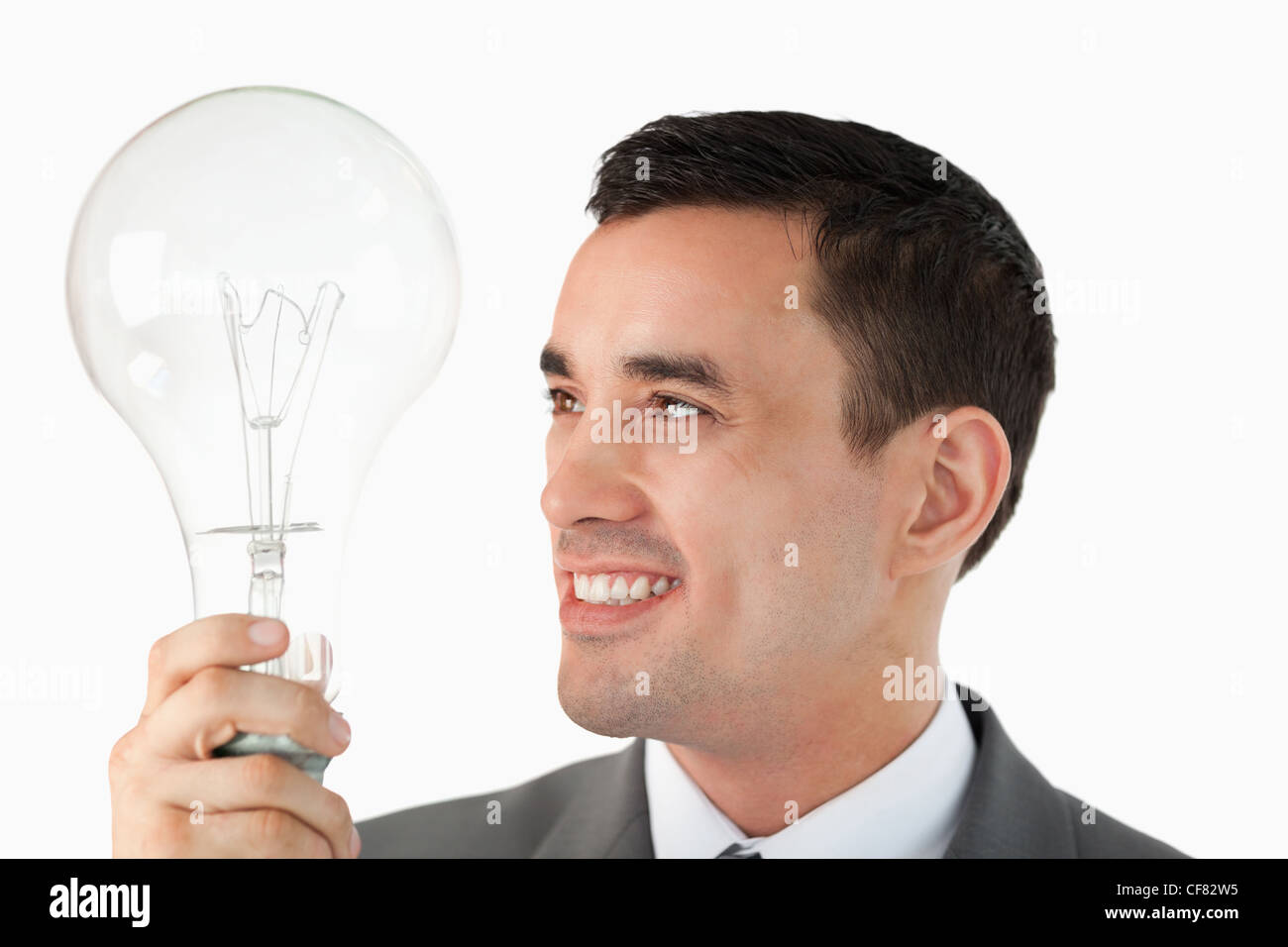Business man holding huge bulb hi-res stock photography and images - Alamy