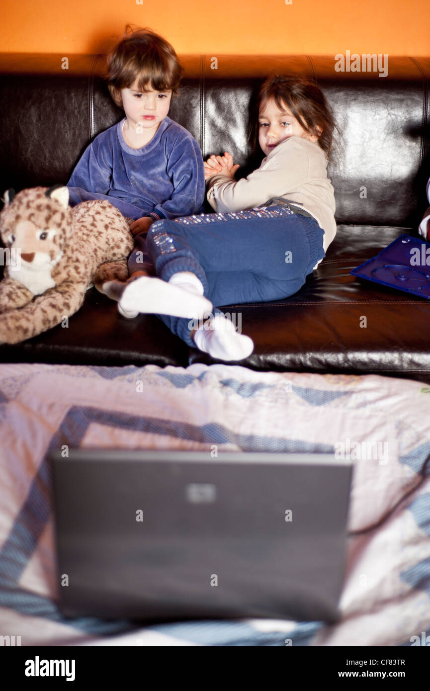 children watch computer in a messy house Stock Photo - Alamy