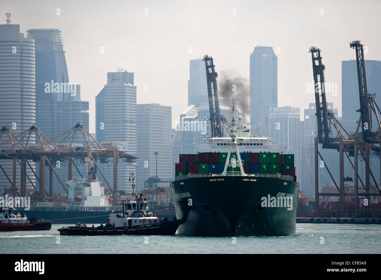 A container ship is maneuvered into position at the Brani terminal of ...