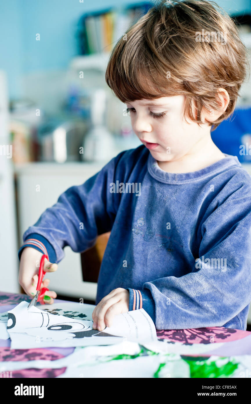 children cut his draw at the table of the kitchen Stock Photo - Alamy
