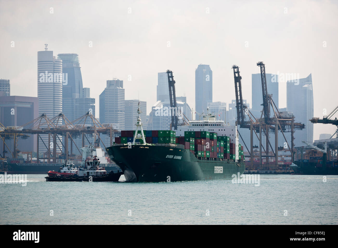 A container ship is maneuvered into position at the Brani terminal of ...