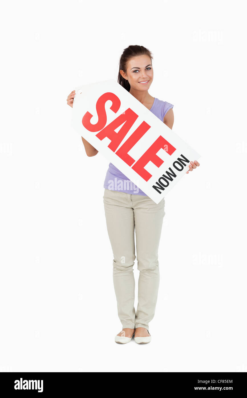 Young female holding a sales sign Stock Photo - Alamy