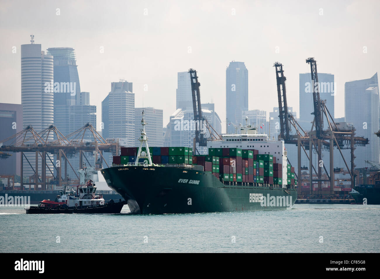 A container ship is maneuvered into position at the Brani terminal of ...