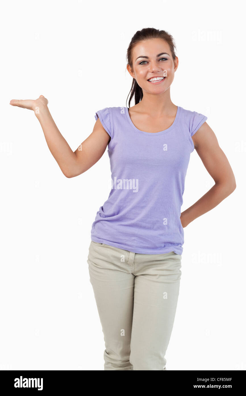Smiling young female presenting Stock Photo - Alamy