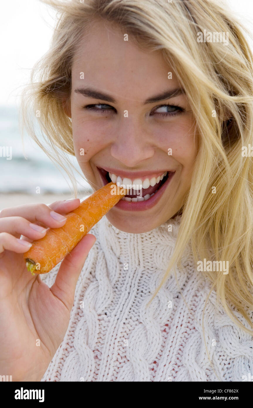 Close up of female long blonde hair wearing cream knitted jumper ...