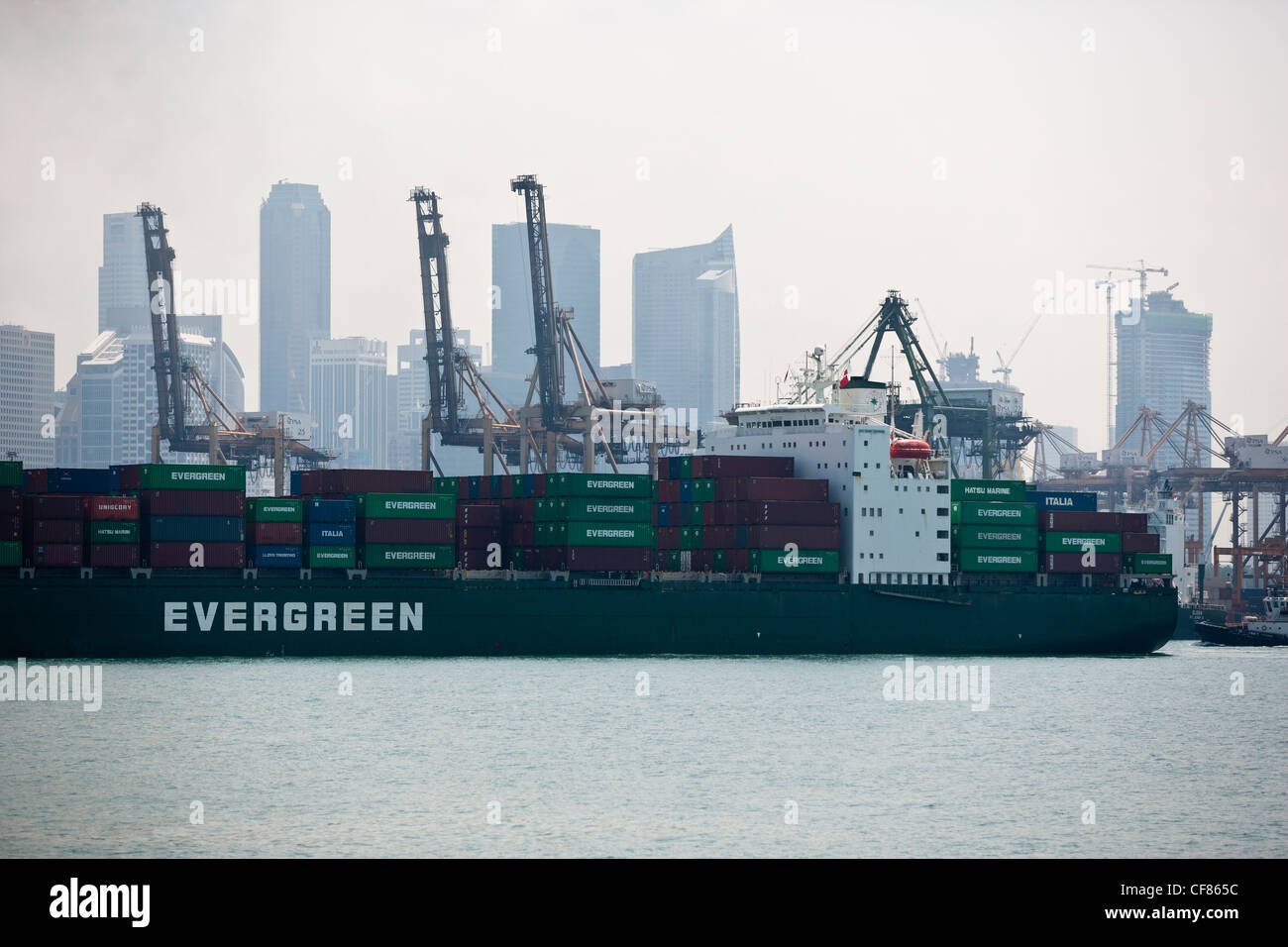 A container ship is maneuvered into position at the Brani terminal of ...