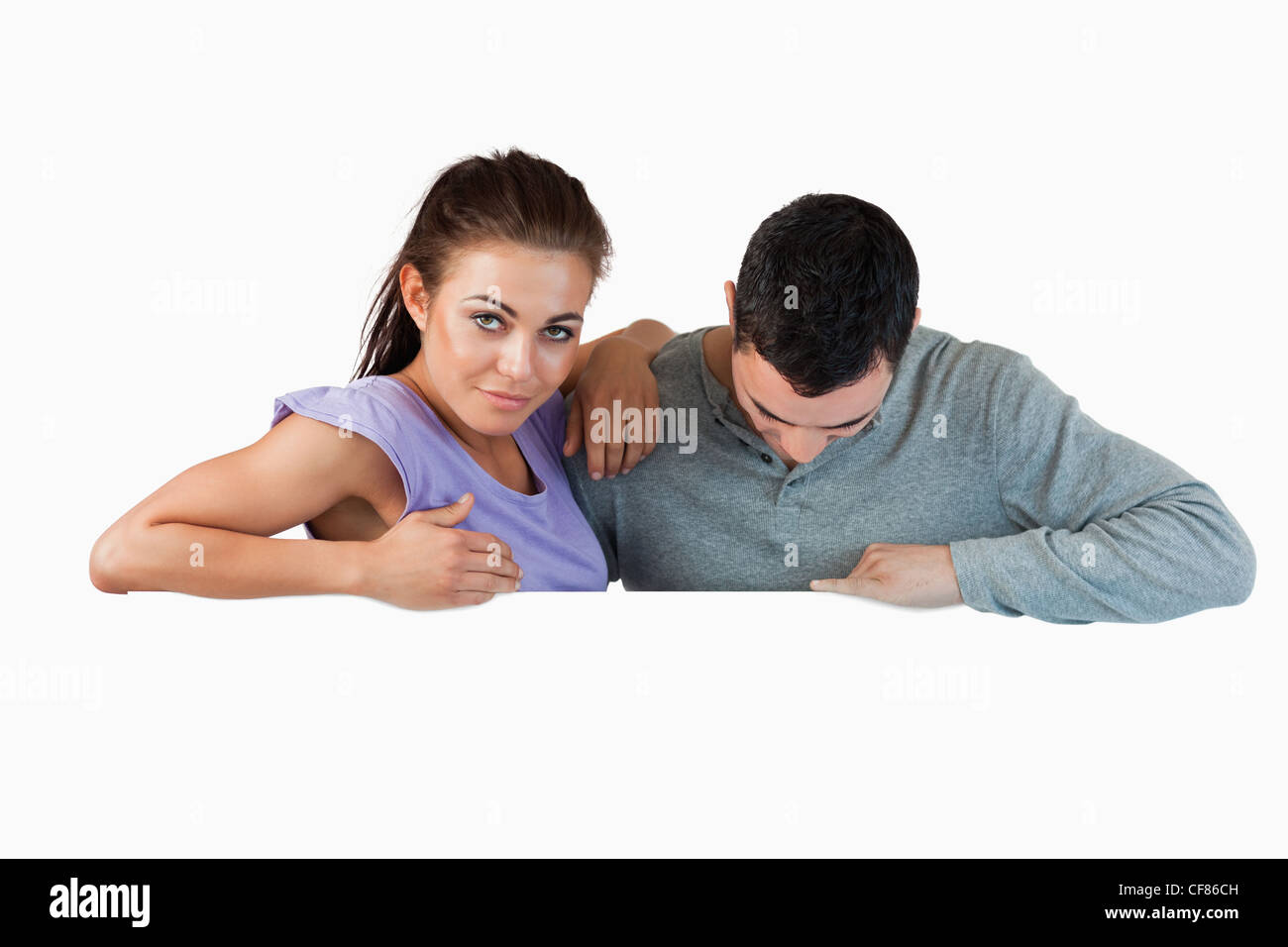 Young couple looking over a wall Stock Photo - Alamy