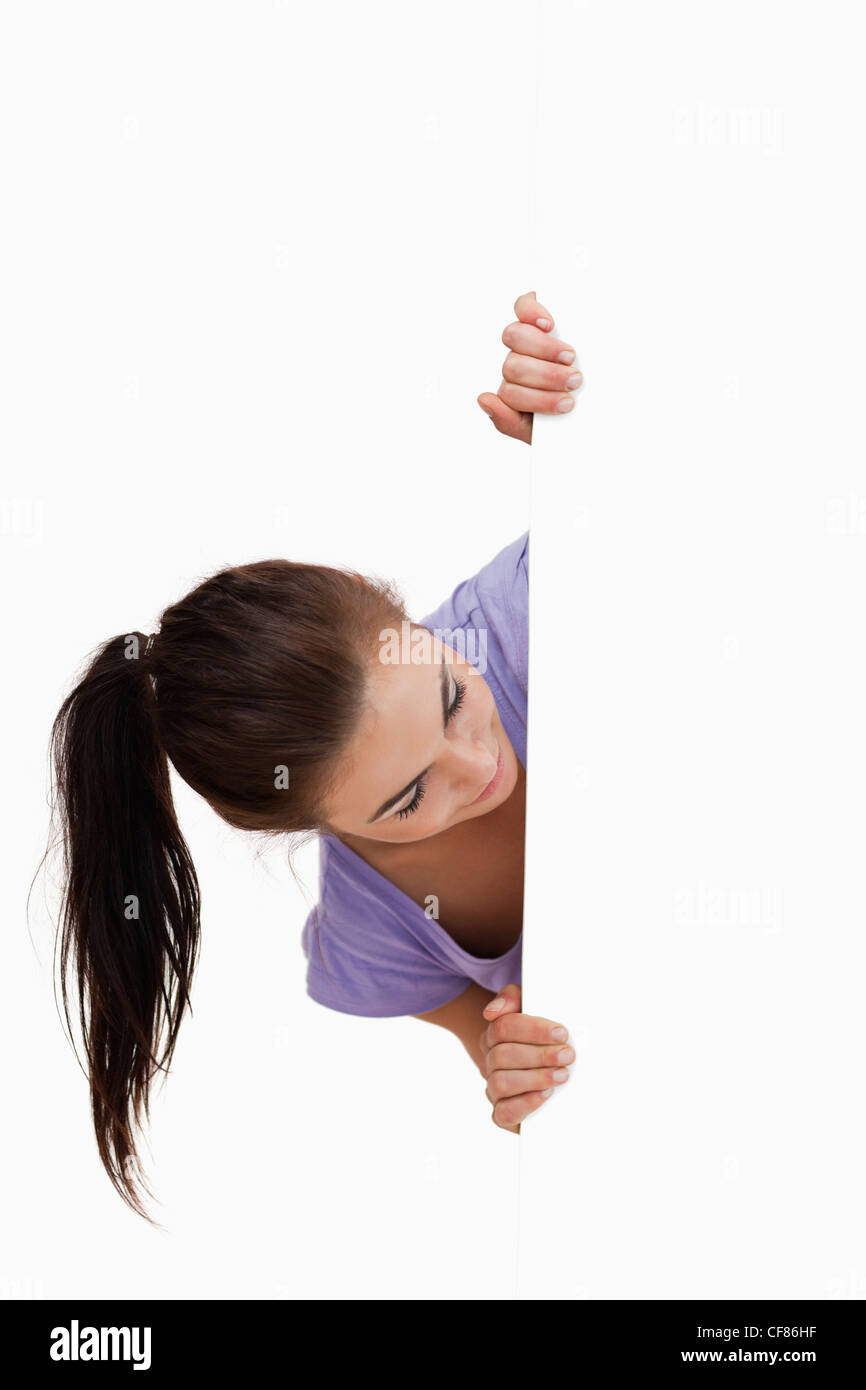 Woman looking around a corner hi-res stock photography and images - Alamy