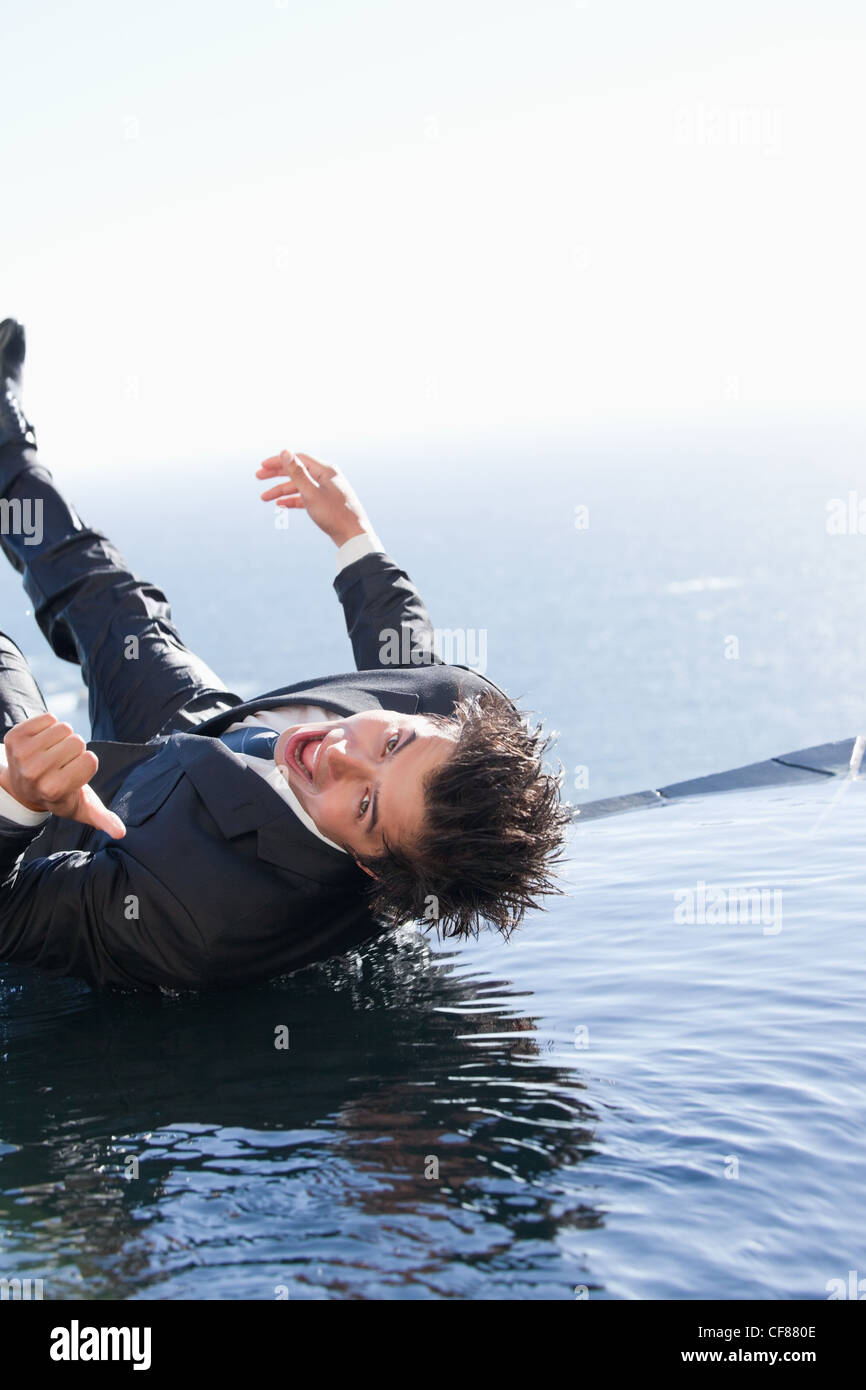 Portrait of a businessman falling into water Stock Photo - Alamy