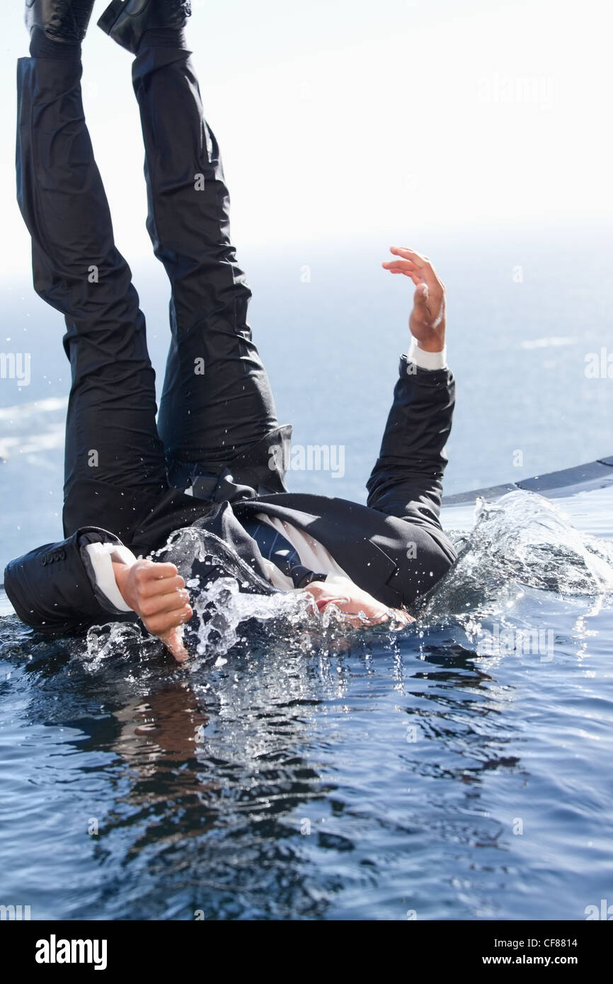 Portrait of a cheerful businessman falling into water Stock Photo - Alamy