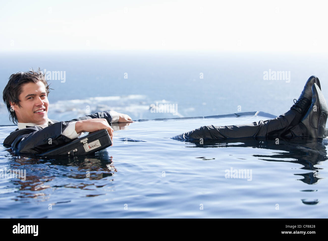 Man sleeping swimming pool hi-res stock photography and images - Alamy