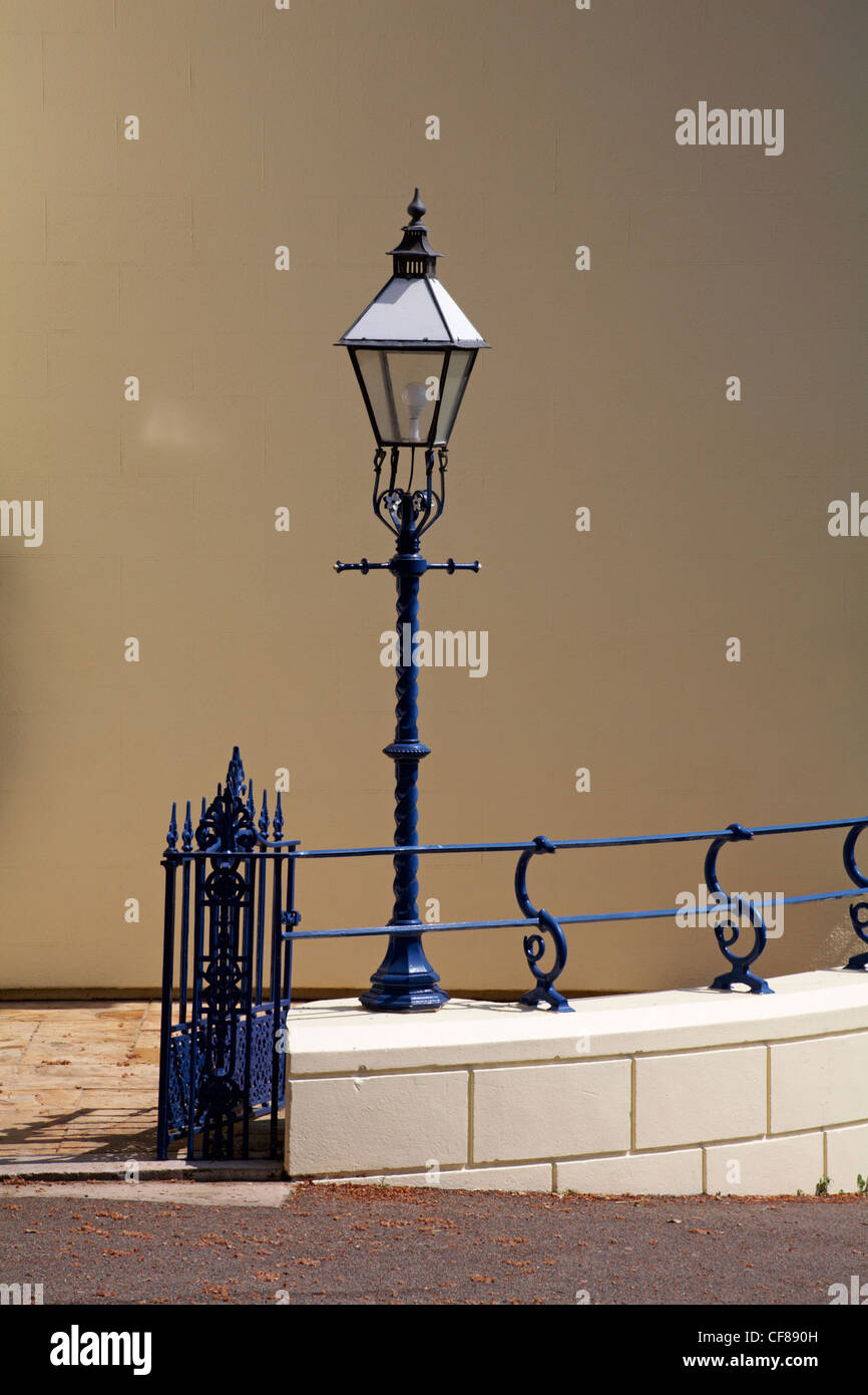 ornate lamppost, gate and railings in front of wall at St Peters Port ...