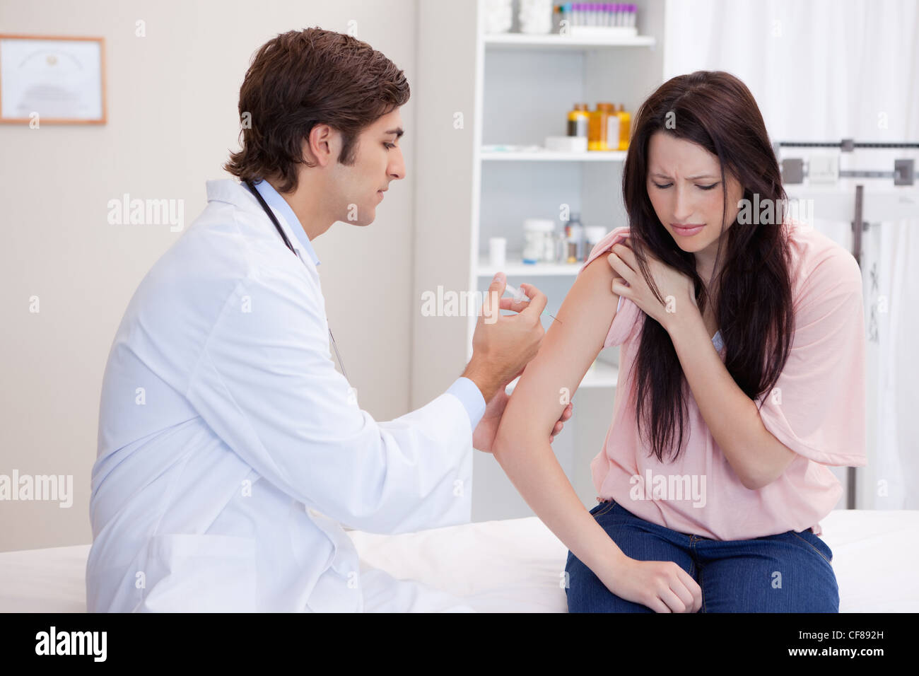 Male doctor giving patient an injection Stock Photo - Alamy