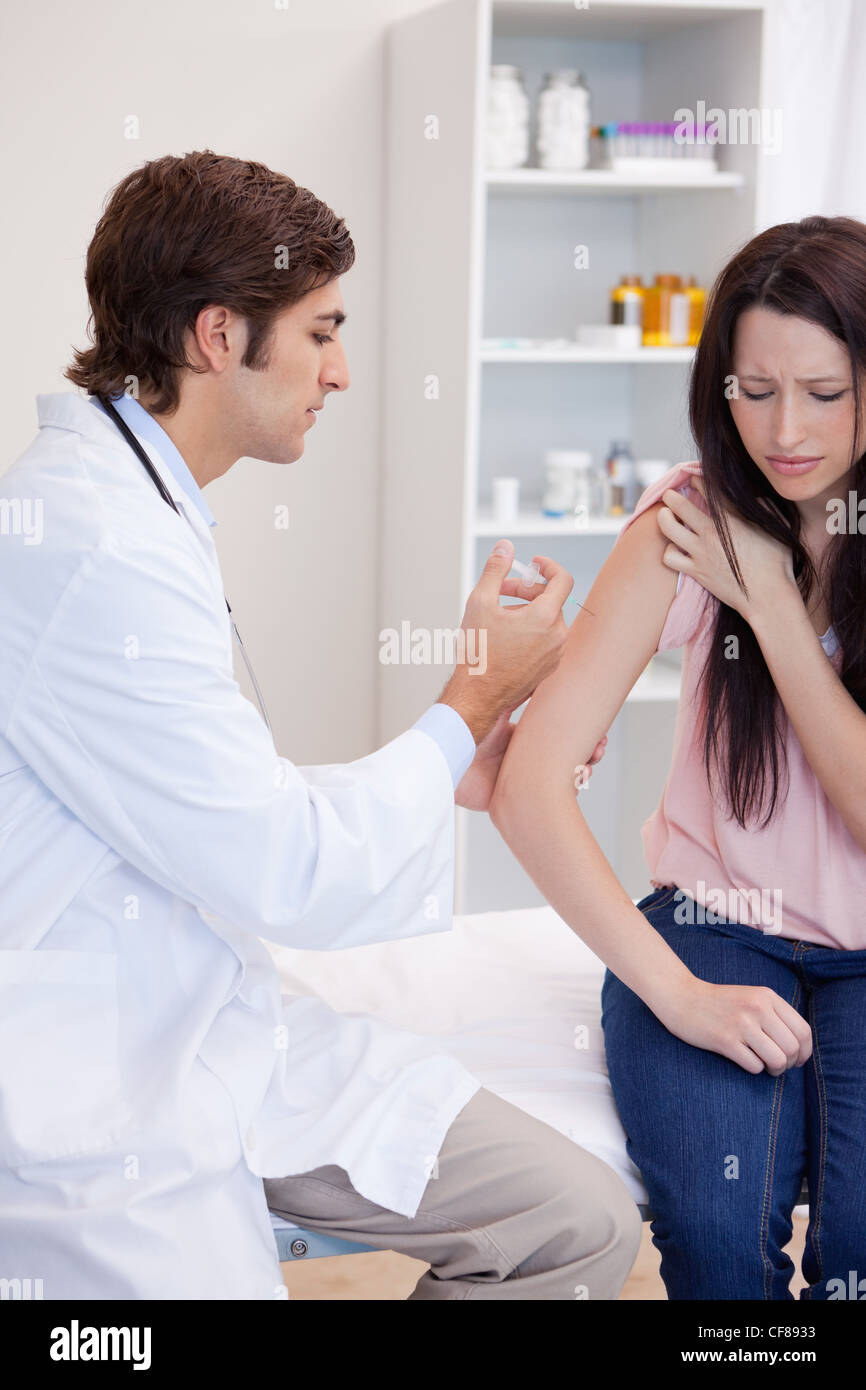 Patient getting an injection by male doctor Stock Photo - Alamy