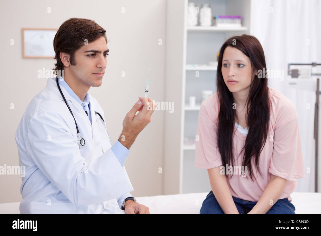 Doctor preparing injection for patient Stock Photo - Alamy