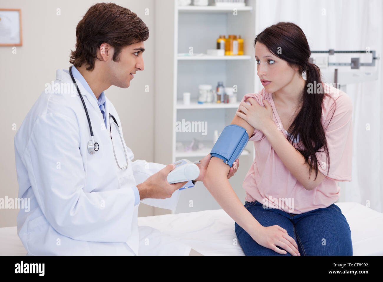 Doctor checking patients blood pressure Stock Photo - Alamy