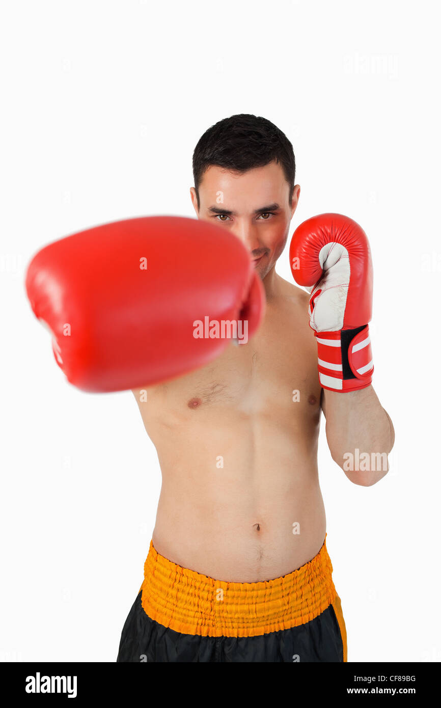 Smiling boxer attacking with his right fist Stock Photo - Alamy