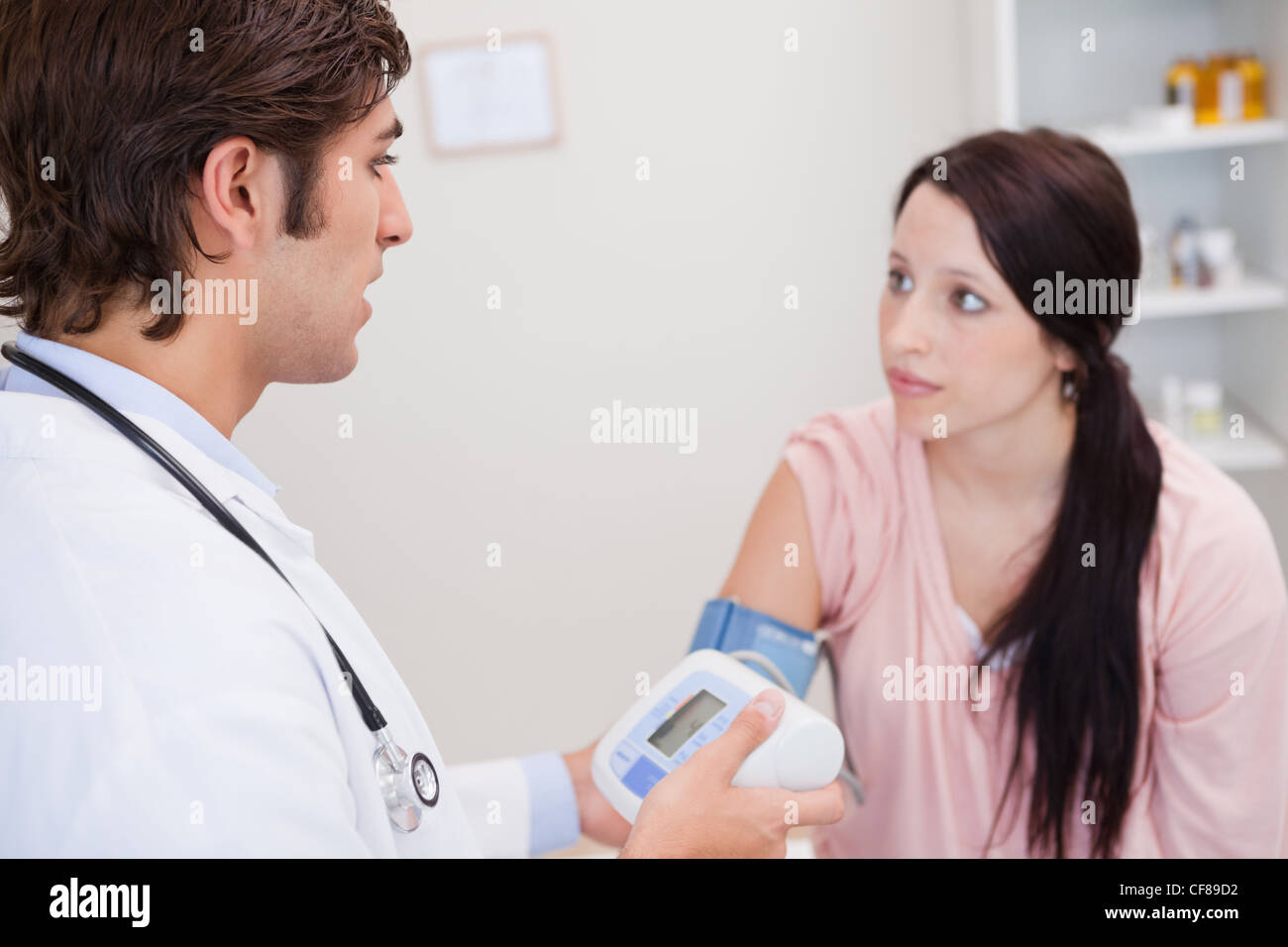 Woman getting her blood pressure checked Stock Photo - Alamy