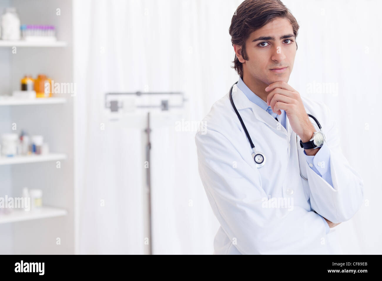 Male doctor standing in examination room Stock Photo - Alamy