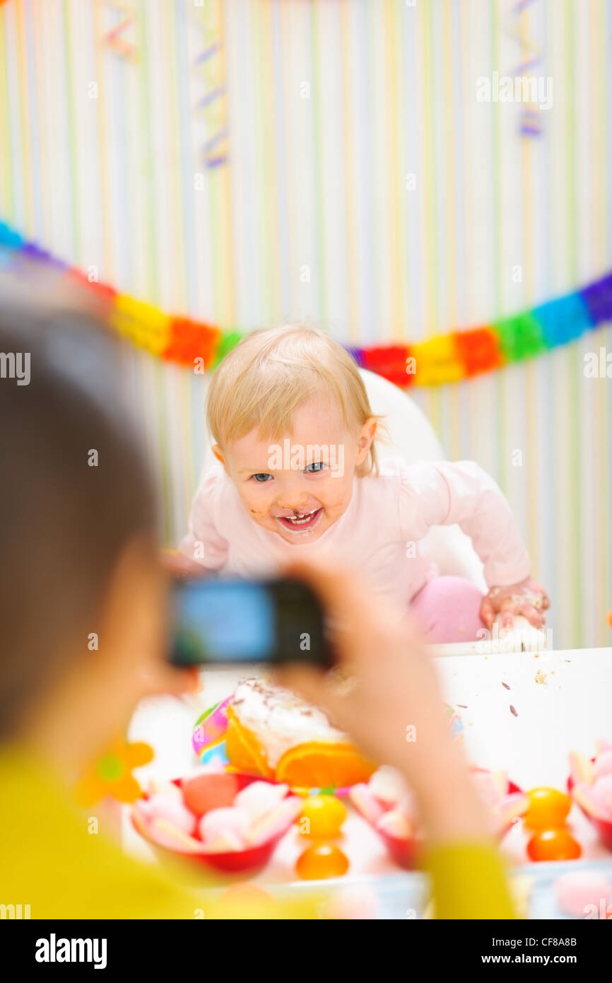 Mother making photos of happy baby on first birthday party Stock Photo ...