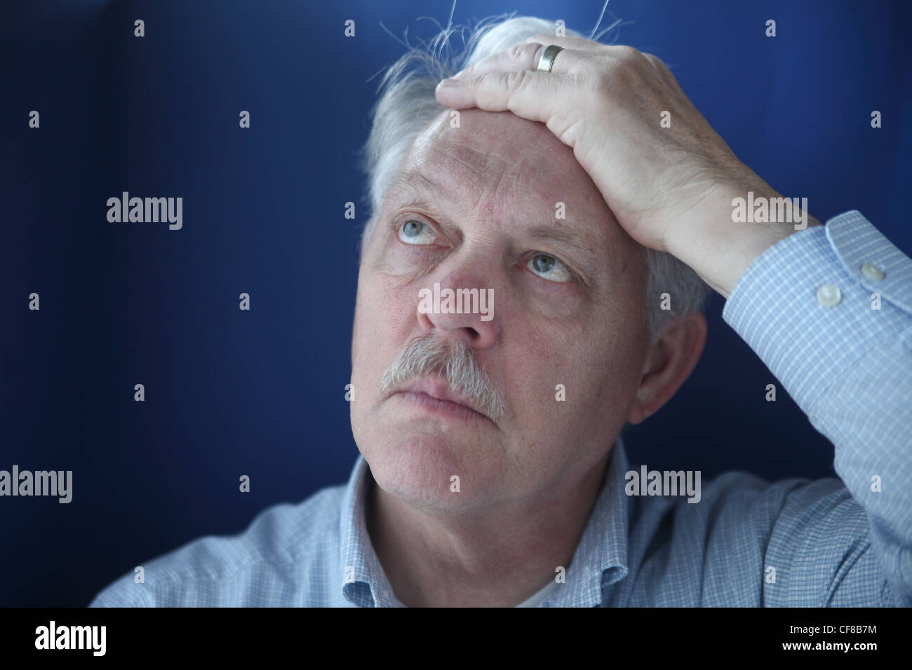 older man is indecisive and perplexed Stock Photo - Alamy