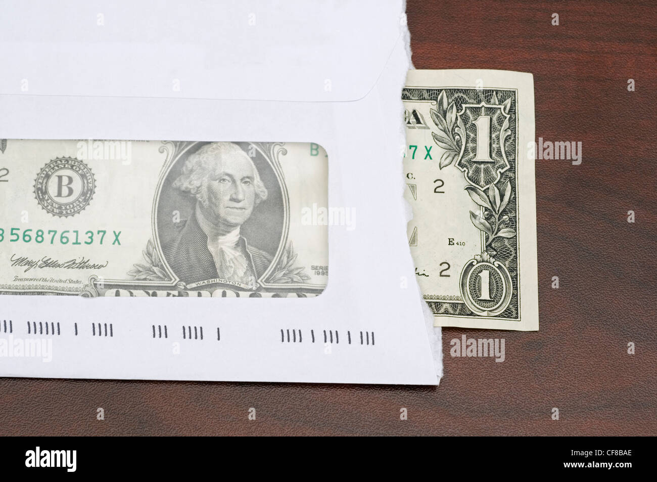 One Dollar in Envelope Stock Photo - Alamy
