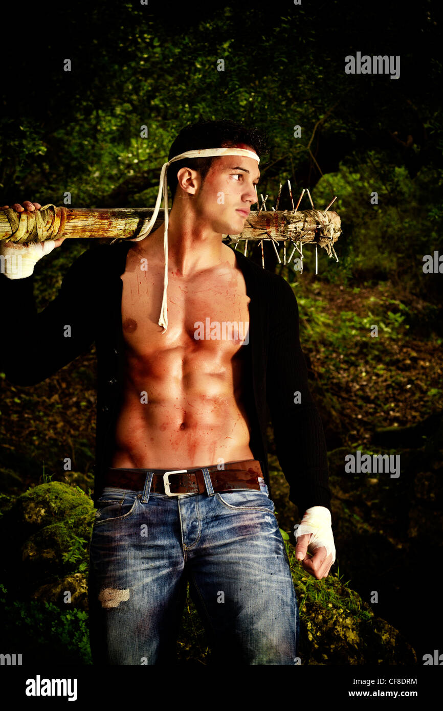 View of a fighter male holding a mace weapon on a forest Stock Photo ...