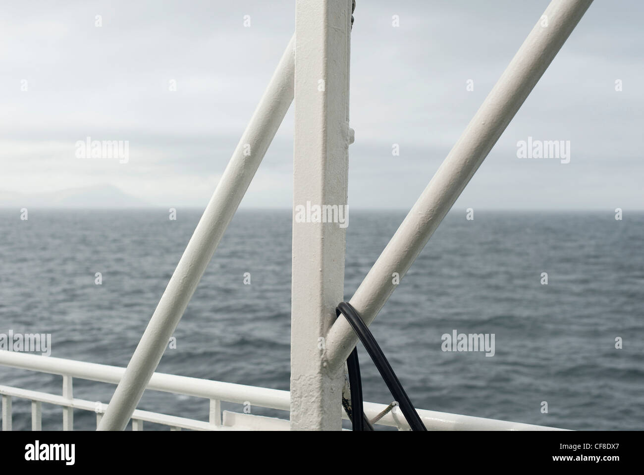 View of metal railings and bars out to sea from a ferry ship with the ...