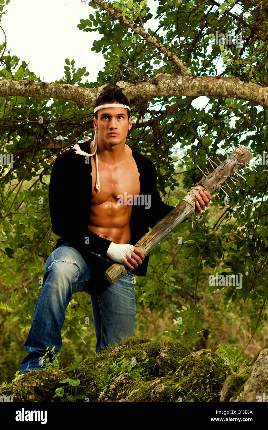 View of a fighter male holding a mace weapon on a forest Stock Photo ...