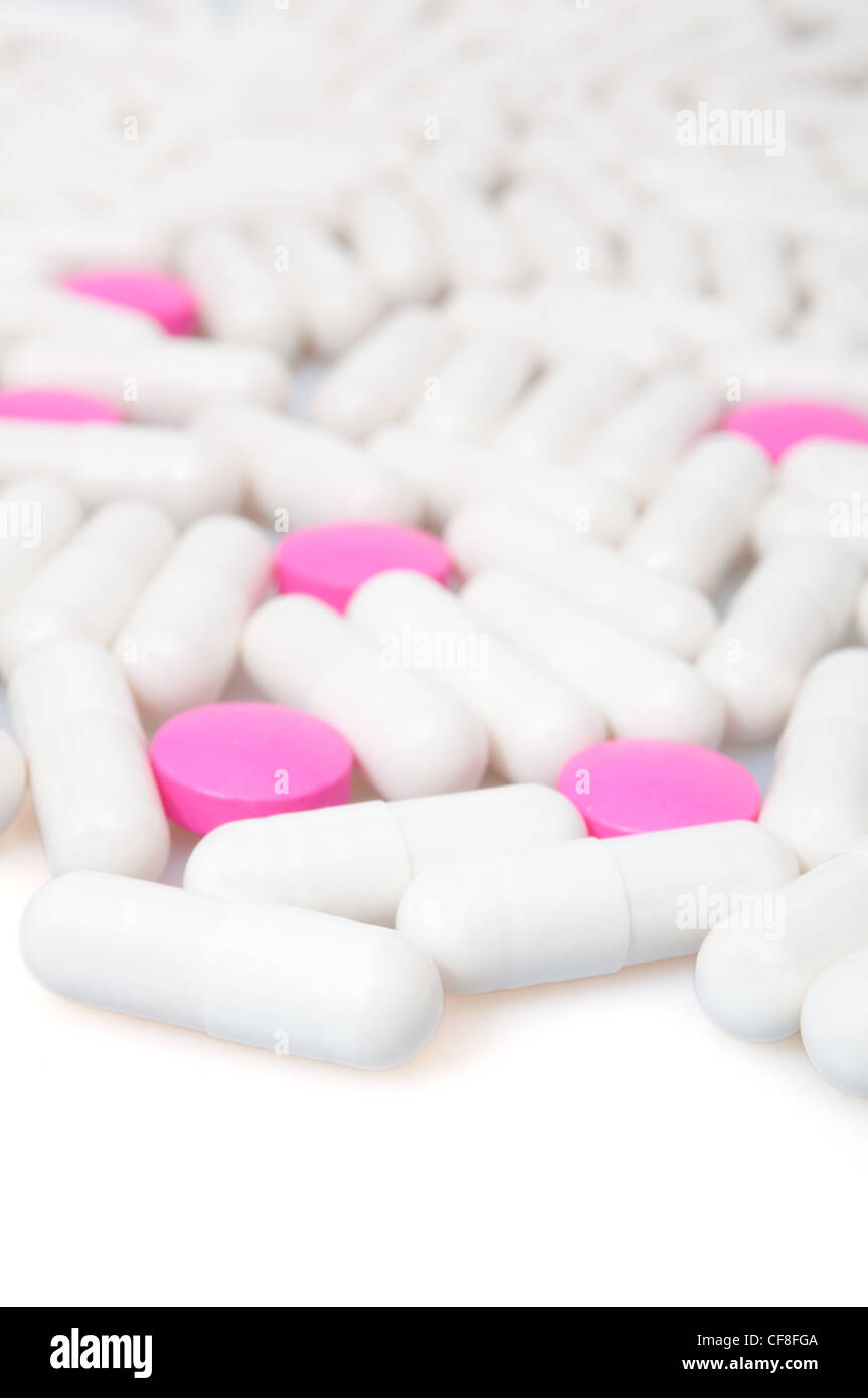 Medical Pink Pills and White Capsule On White Background Stock Photo ...