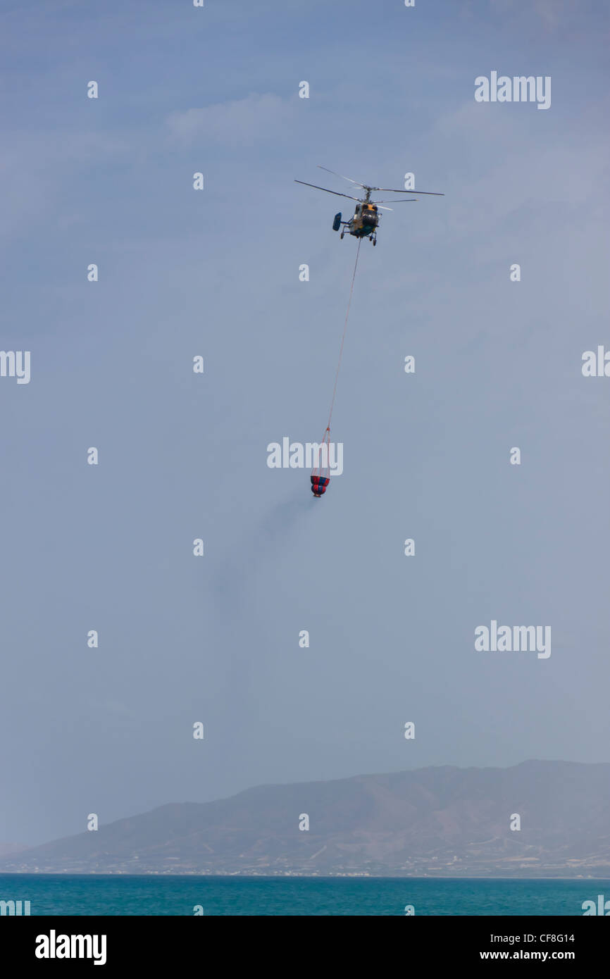 Fire fighting helicopter in flight Stock Photo - Alamy