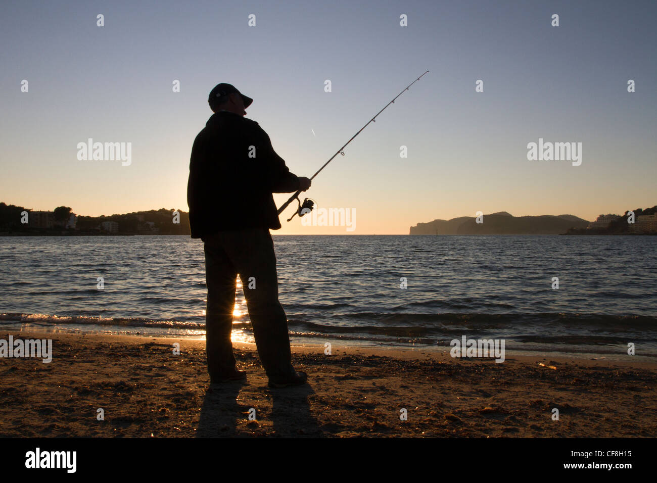 fisherman on sunset fishing silhouettes Stock Photo - Alamy