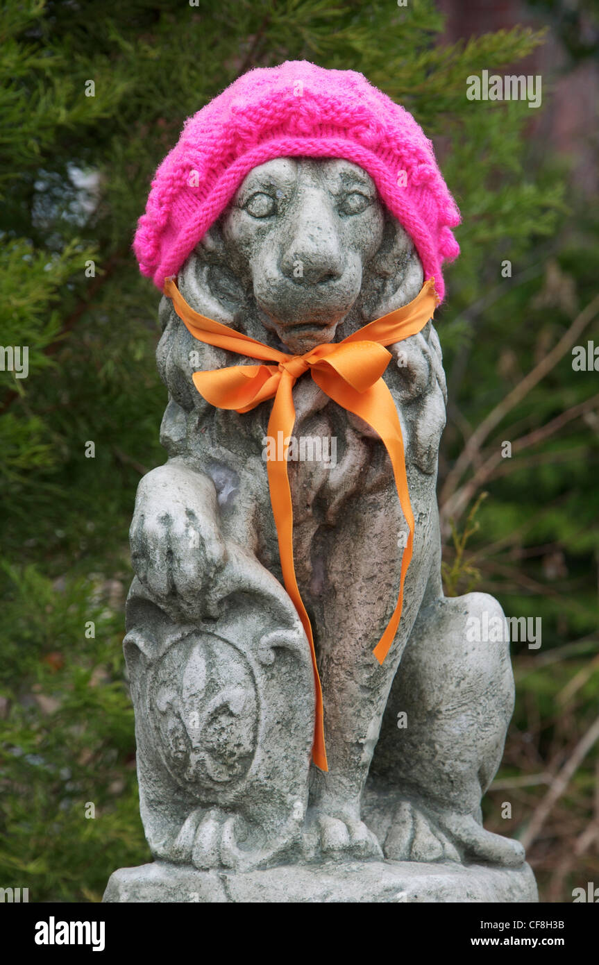 These ornamental stone lions are wearing vividly pink knitted woolly ...