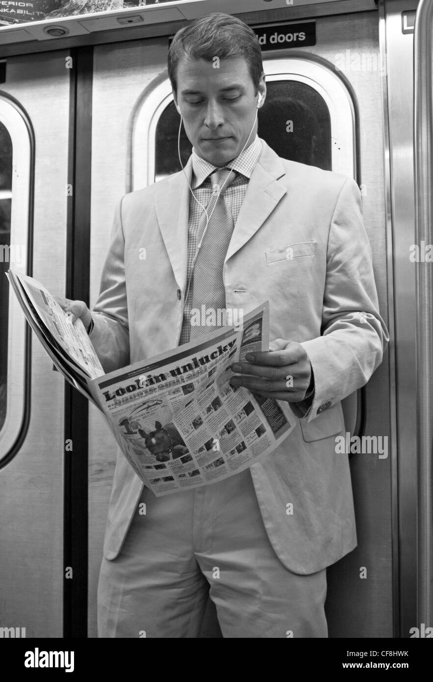 People reading newspaper in subway hi-res stock photography and images ...