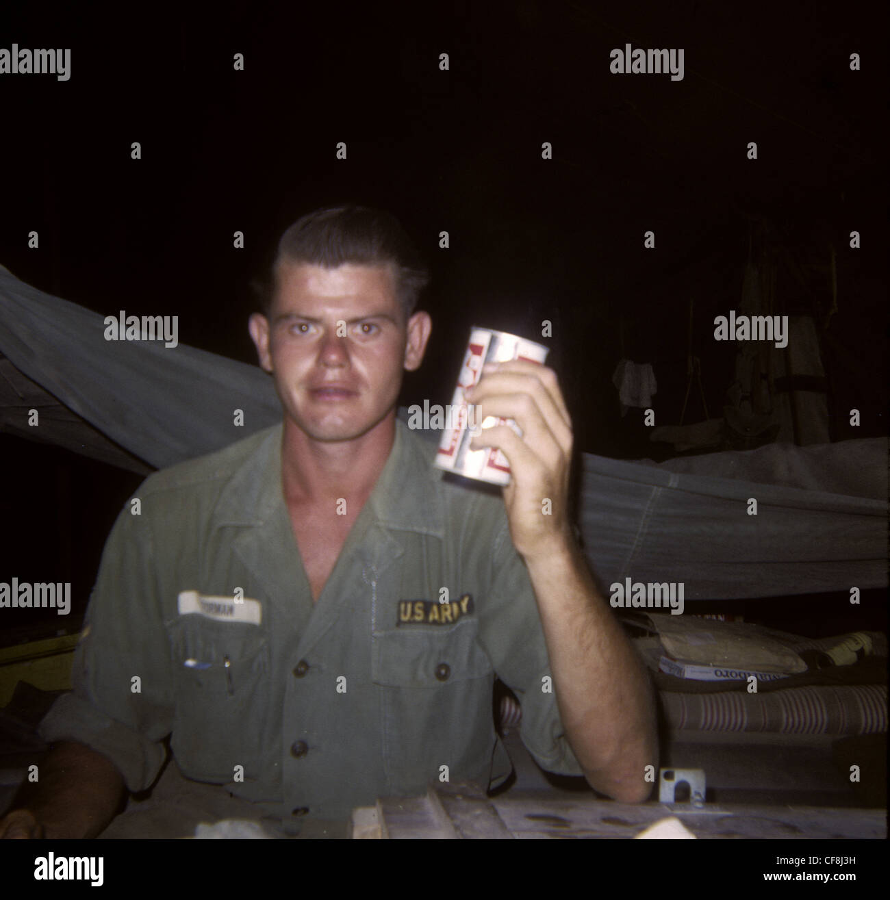 American solider in OD green uniform holding budweiser beer ration 1 ...