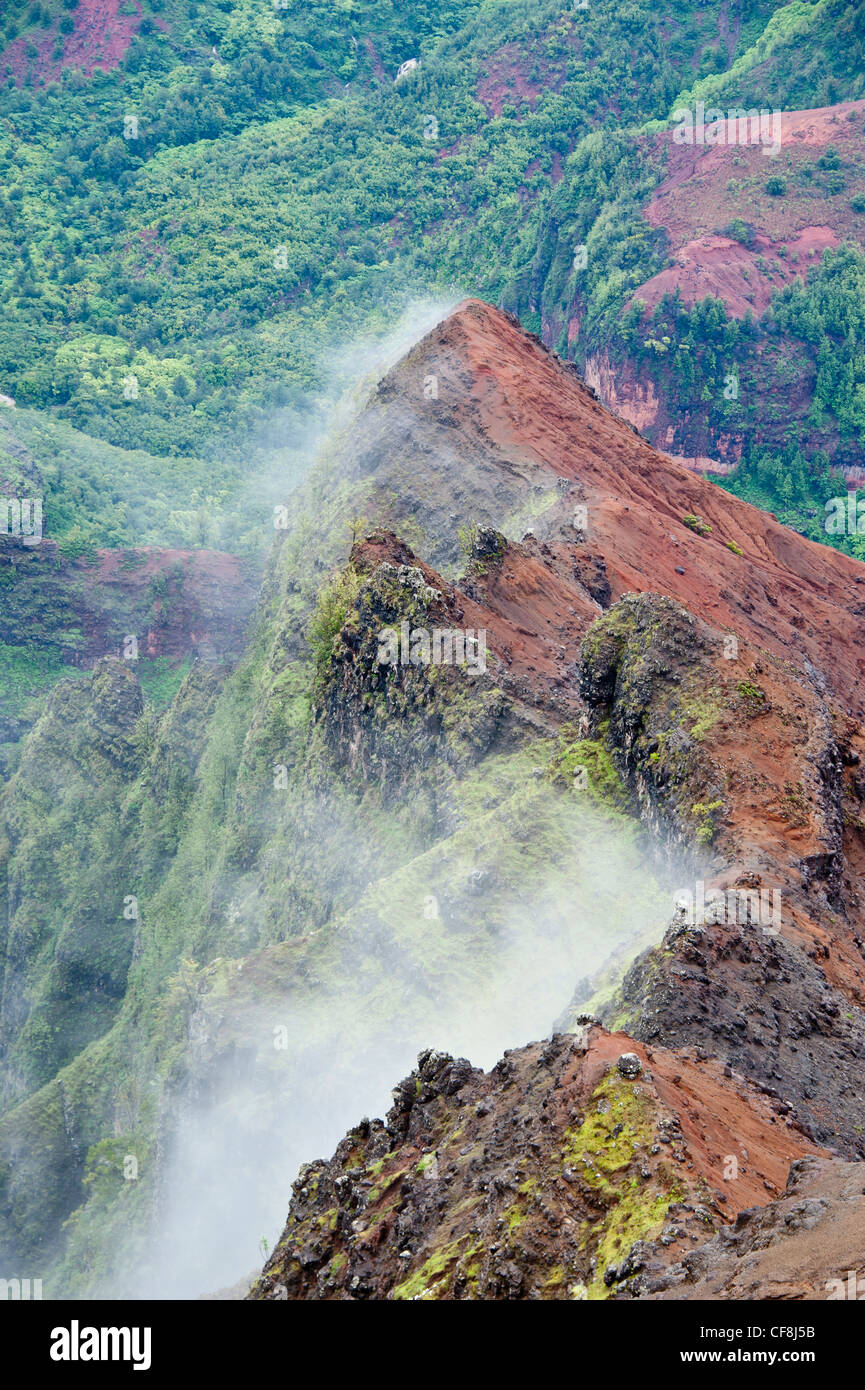 Mist rolling across the top of a peak in the Waimea Canyon, Kauai ...