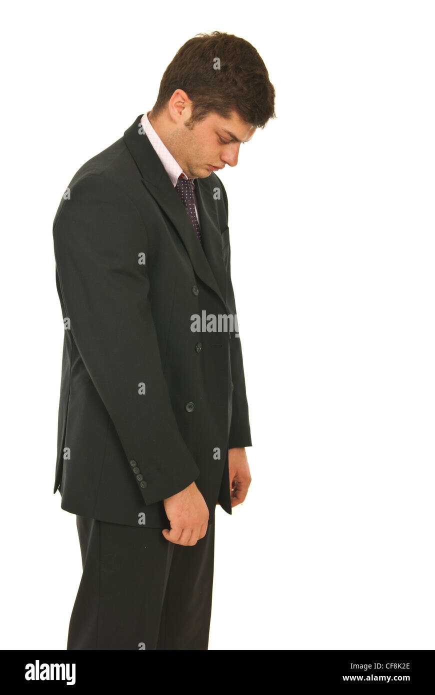 Unhappy business man looking down and walking isolated on white ...