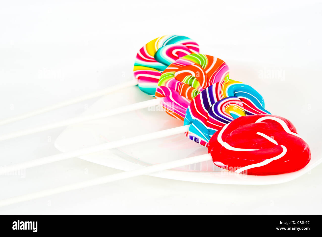 Heart shape Swirl lollipop on white background Stock Photo - Alamy