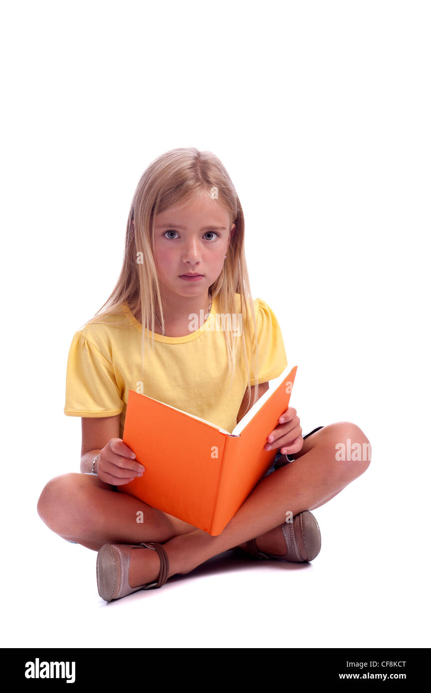 girl, 10 year sold reading an orange book. isolated on white backgroud ...