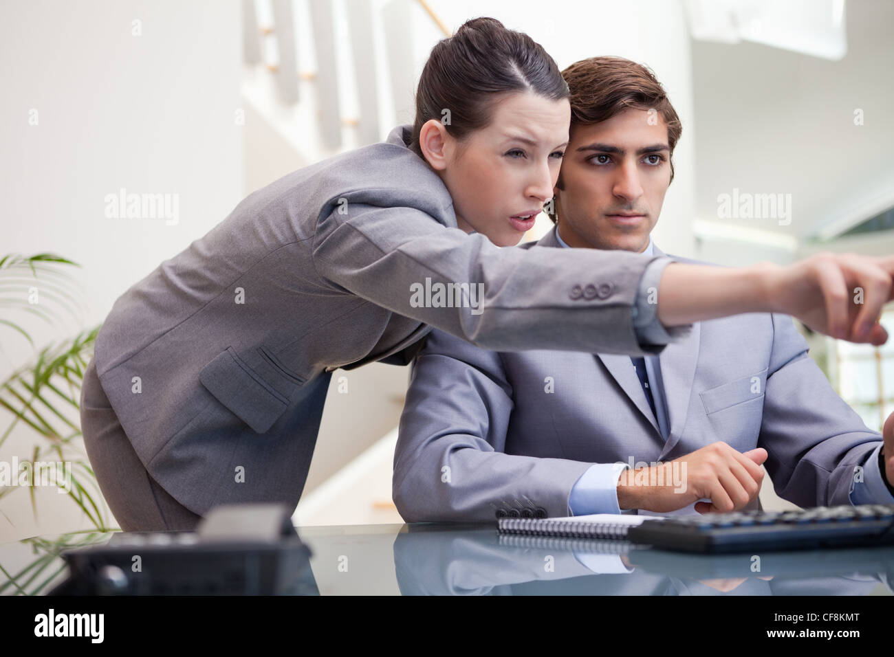 Businesswoman explaining computer program to colleague Stock Photo - Alamy