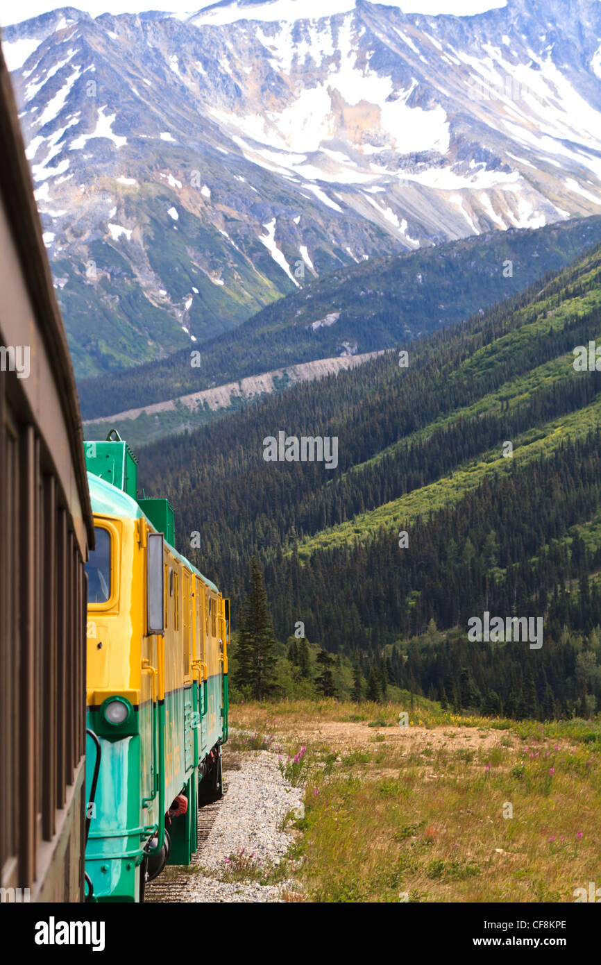 a train moving slowly through the mountain side Stock Photo - Alamy