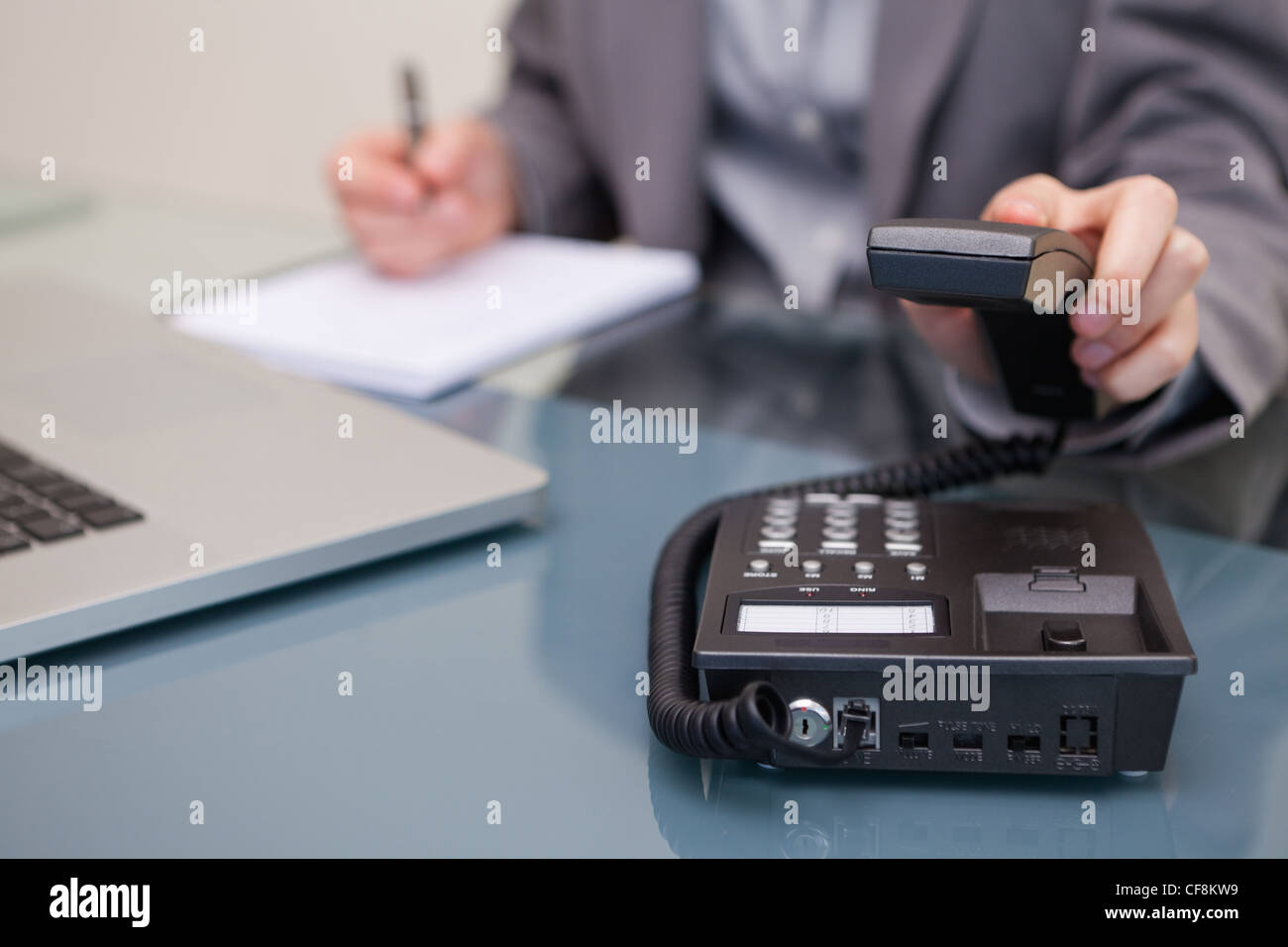 Telephone being hung up by businesswoman Stock Photo - Alamy