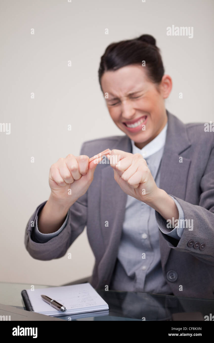 Angry businesswoman breaking pencil Stock Photo - Alamy