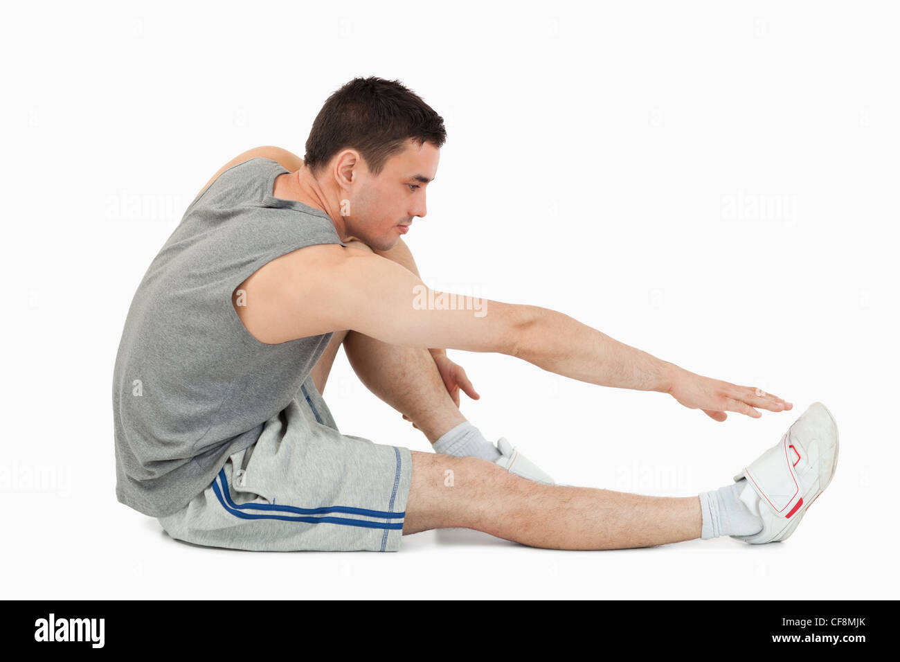 Muscular young man stretching Cut Out Stock Images & Pictures - Alamy