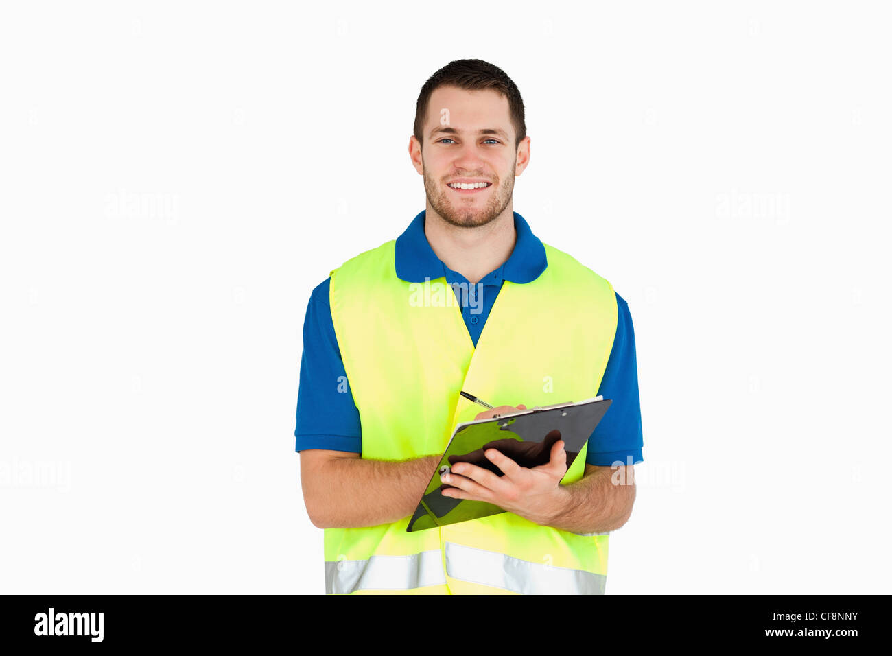 Smiling young delivery man completing delivery note Stock Photo - Alamy
