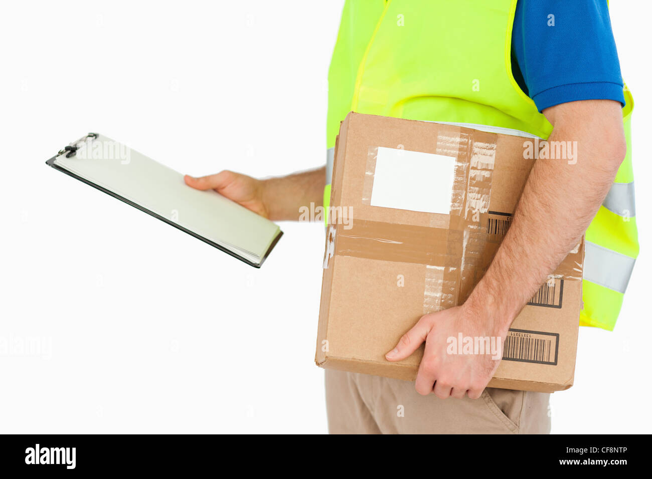Side view of young delivery man with delivery note and parcel Stock ...