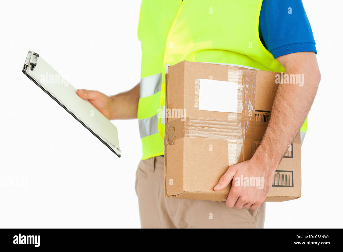 Side view of delivery man with delivery note and parcel Stock Photo - Alamy