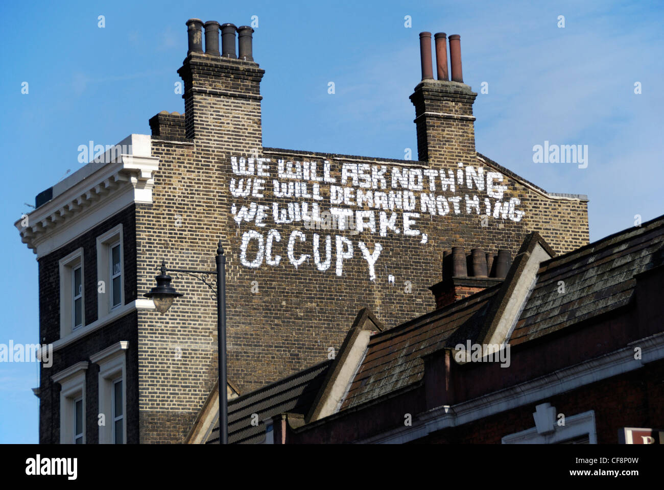 Occupy ‘ movement slogan painted on the side of a building, City of ...